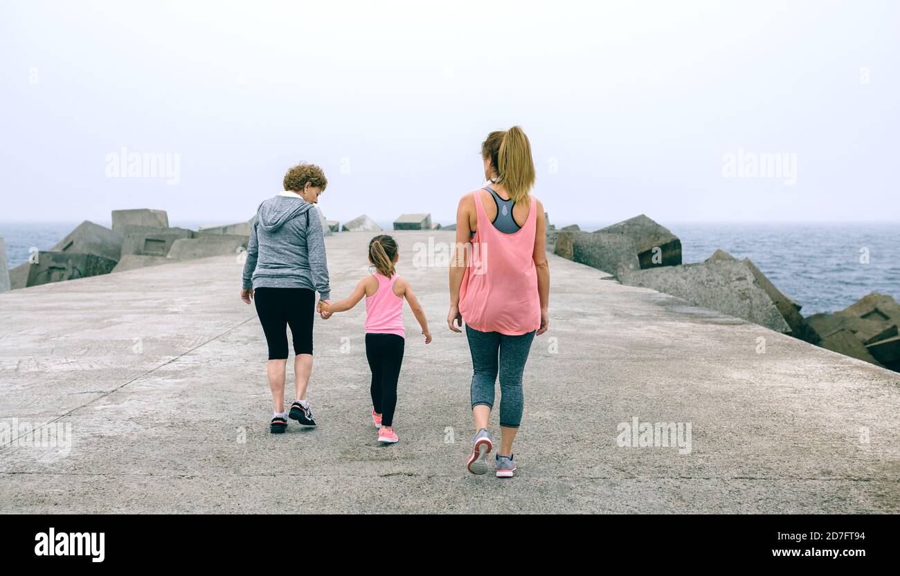 Back view of three female generations walking Stock Photo - Alamy