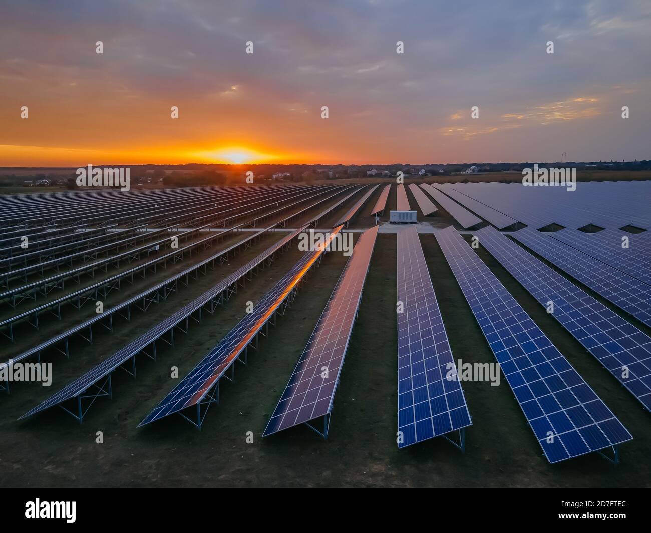 Aerial drone view of large solar panels at a solar farm at bright ...
