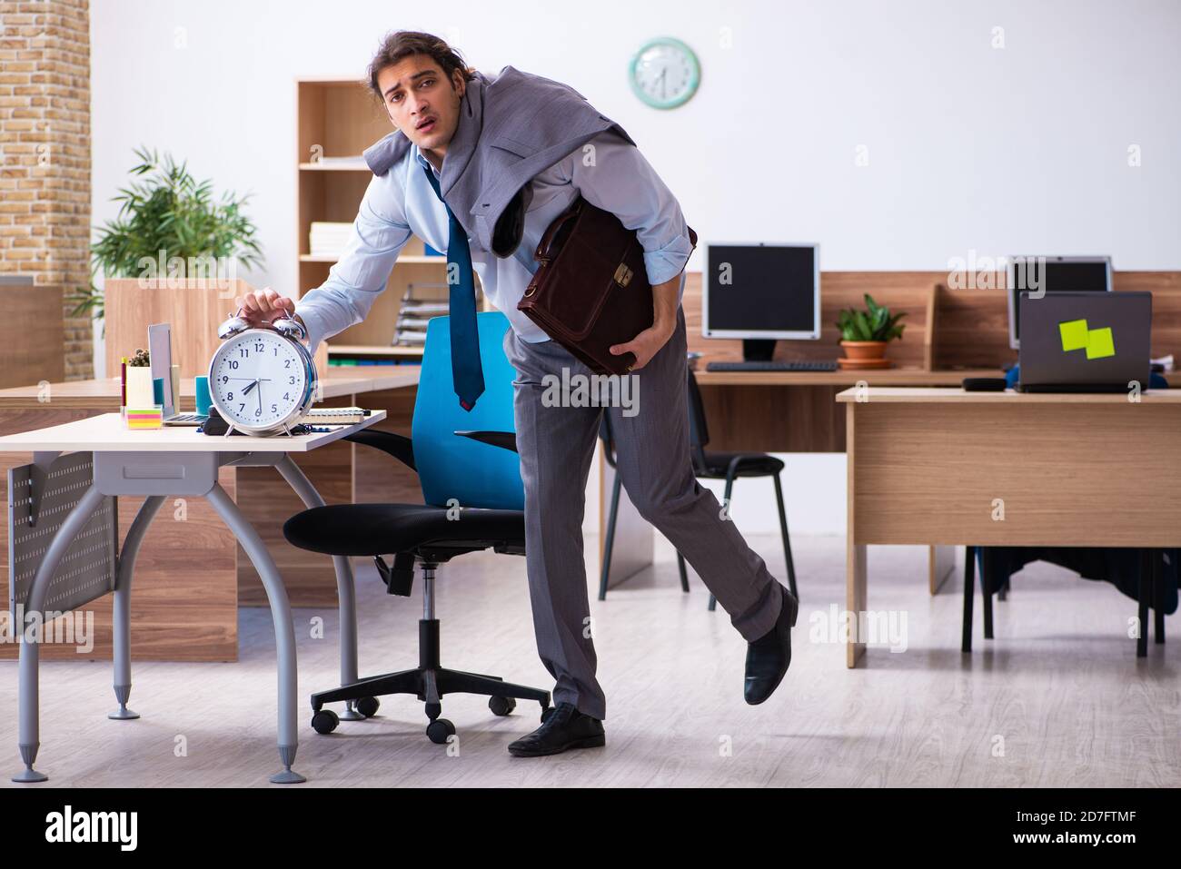 Male employee being late for his job Stock Photo - Alamy