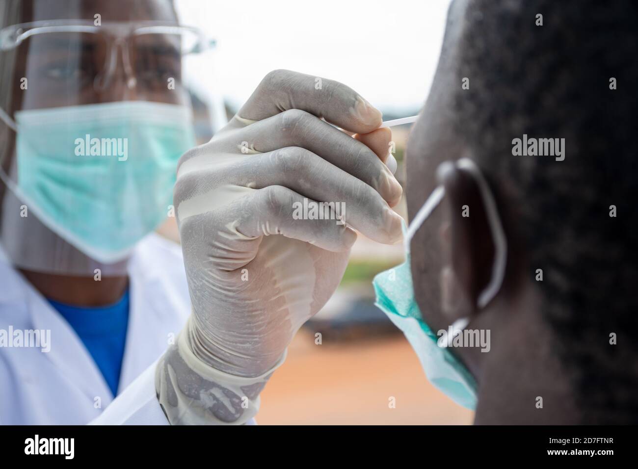 young black lab scientist taking nasal sample from a patient Stock ...