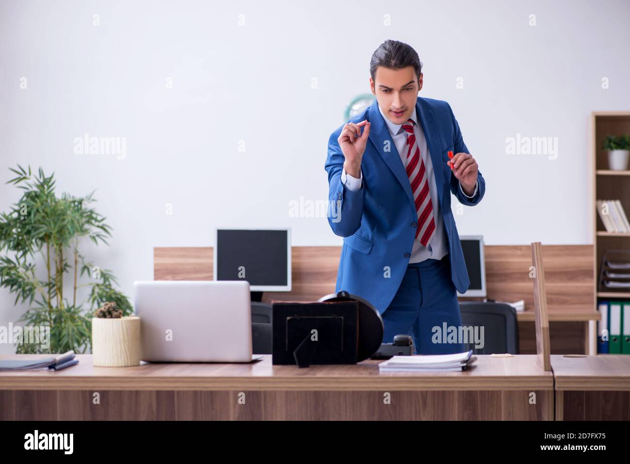 Young employee playing darts in the office Stock Photo - Alamy