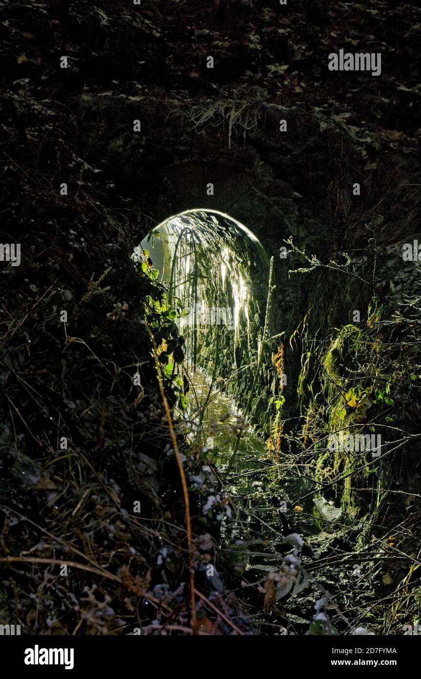 Arched mine entrance to a tunnel to the workings, also known as an adit ...