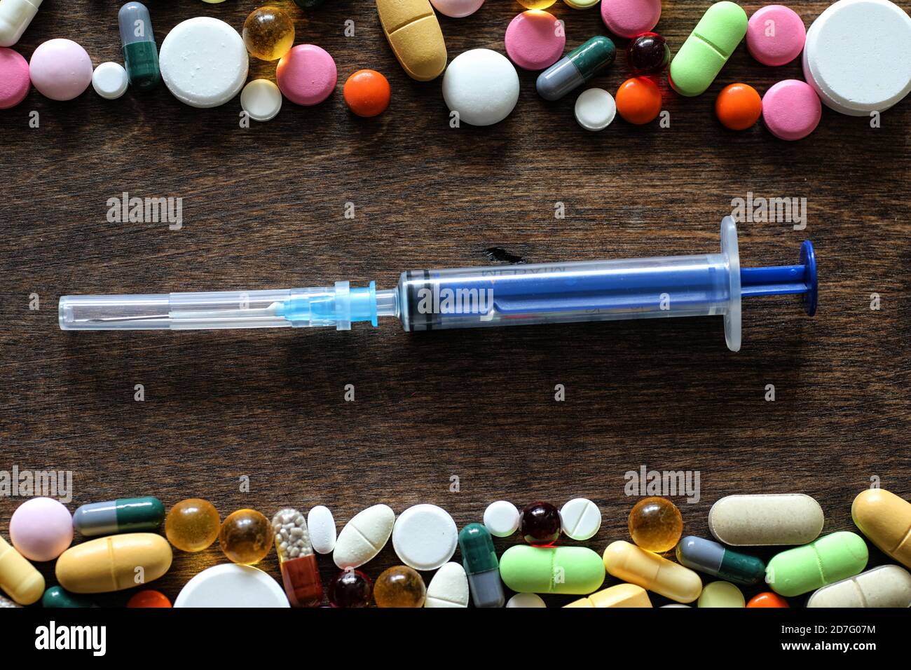 Medical background of various colorful medications on a textured wooden ...