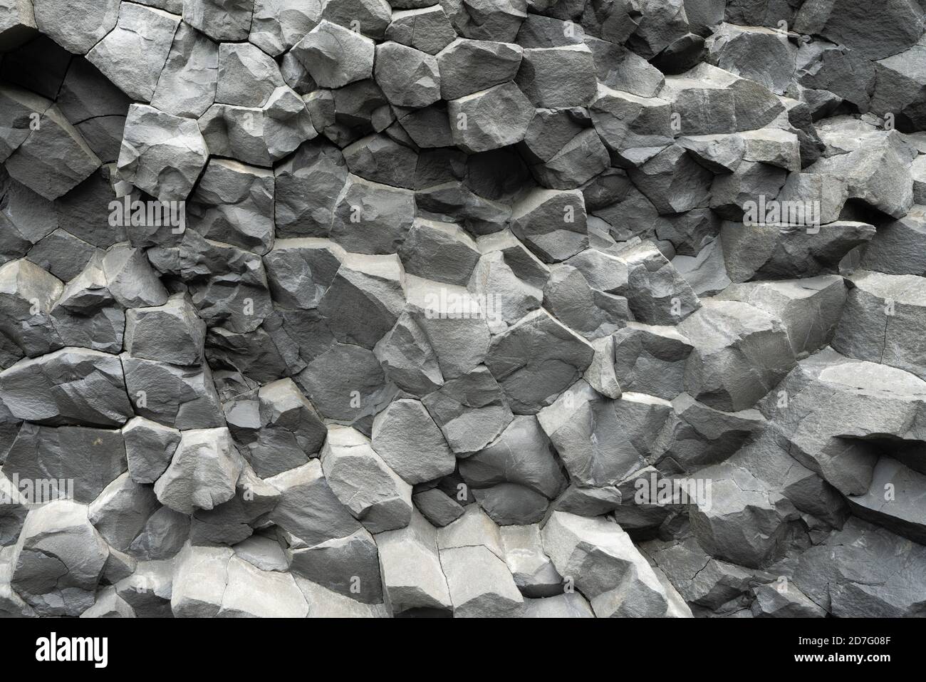 Backdrop from basalt volcanic rock formations in Reinisfjara beach near ...