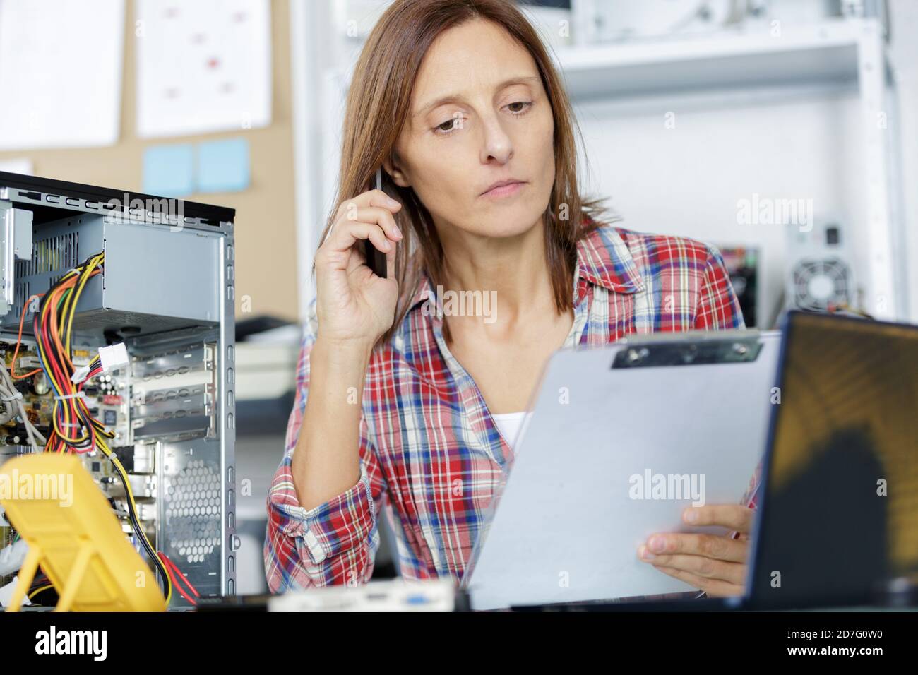 a woman fixing a pc Stock Photo - Alamy