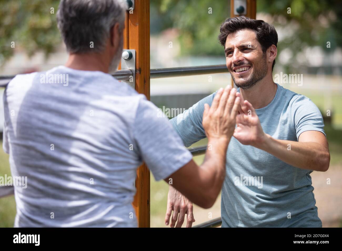 happy runners giving high five during running Stock Photo - Alamy