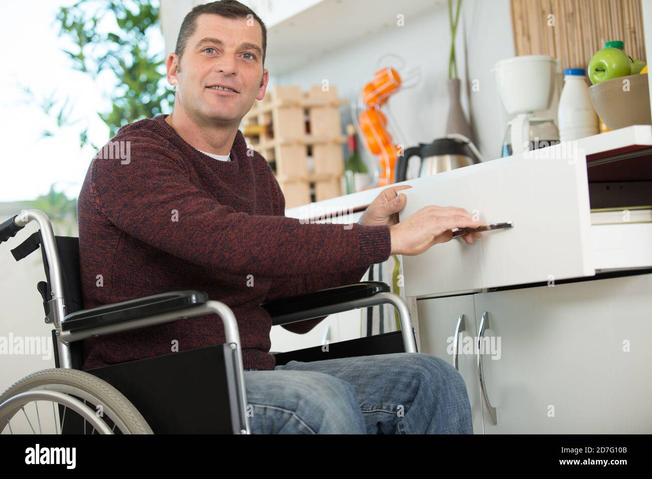 happy disabled man in a wheelchair in the kitchen Stock Photo - Alamy