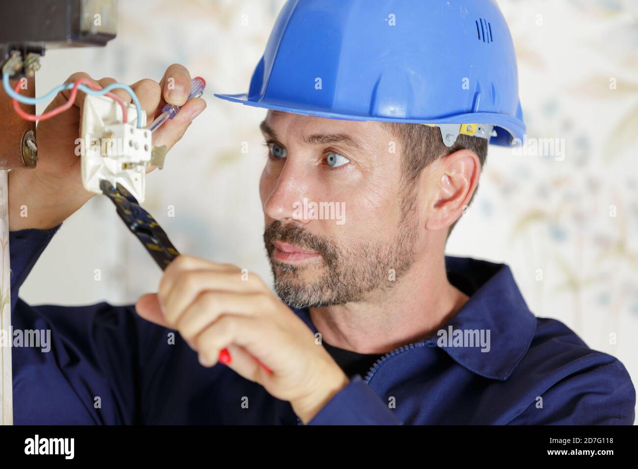 electrician installing socket in new house Stock Photo - Alamy