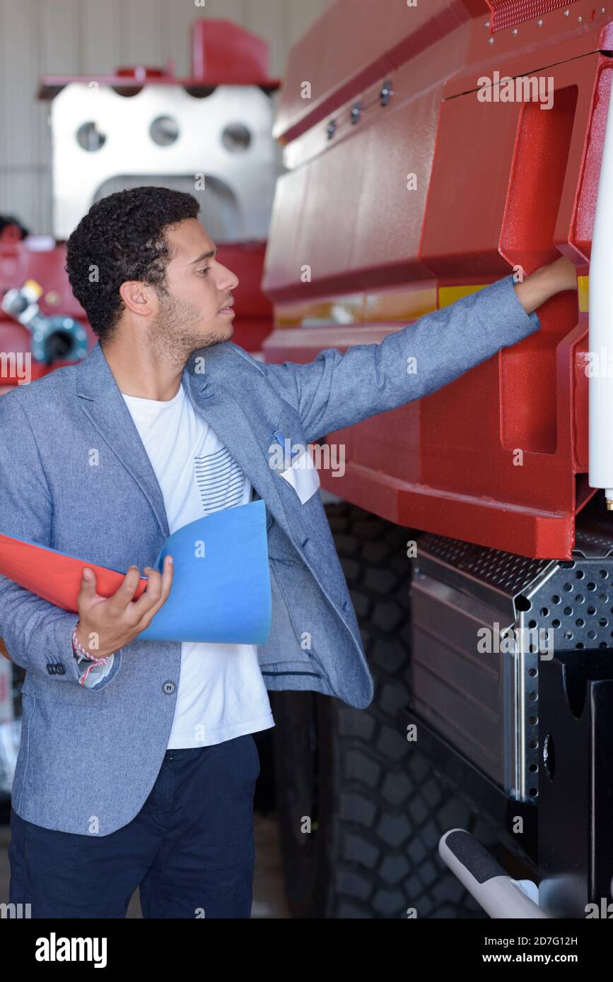portrait of a engineer supervising lorry Stock Photo - Alamy