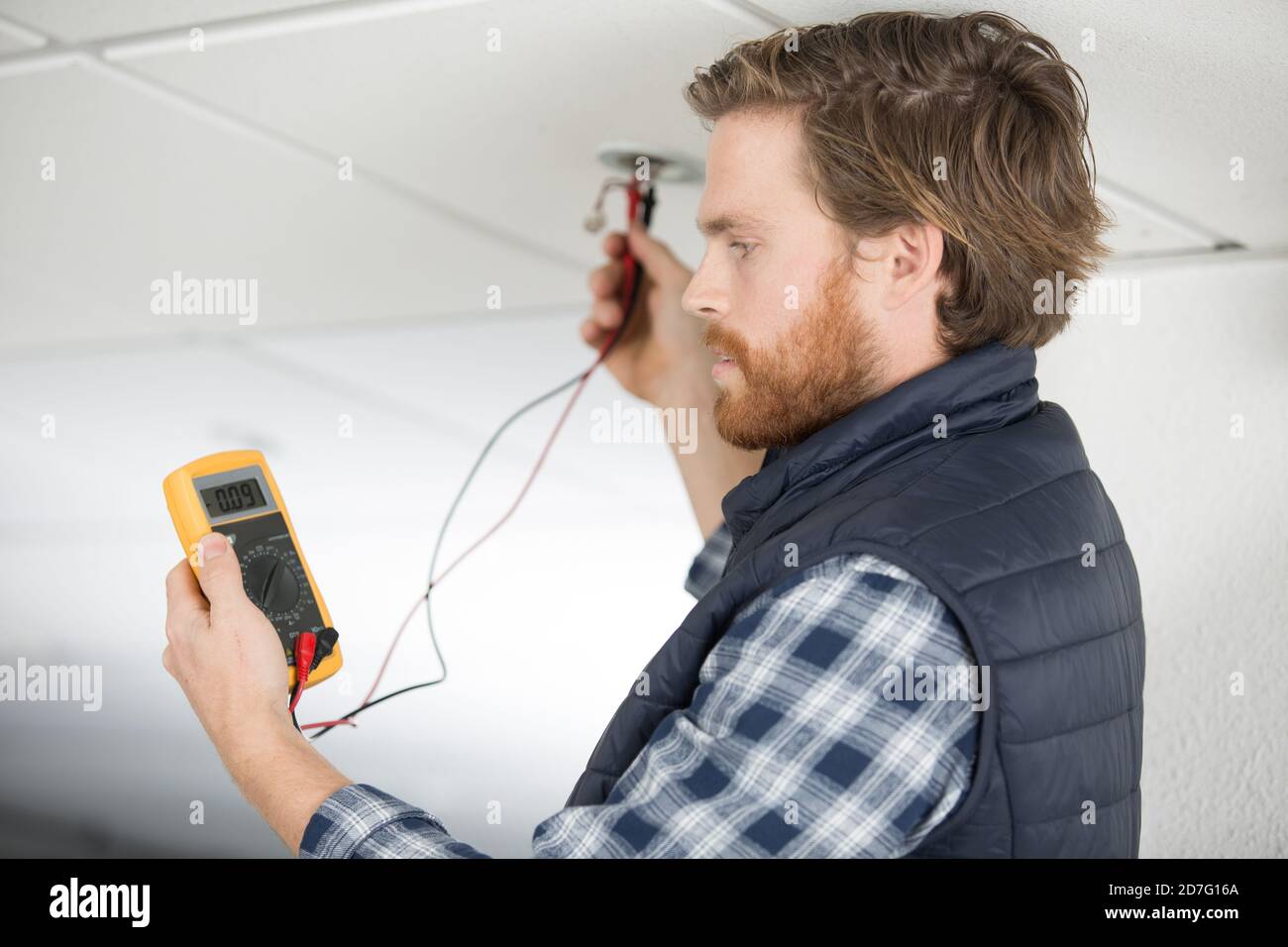 man electrician in uniform measures voltage Stock Photo - Alamy