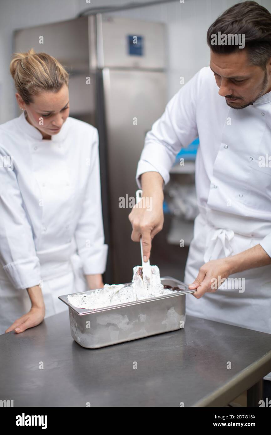 two happy workers preparing ice cream Stock Photo - Alamy
