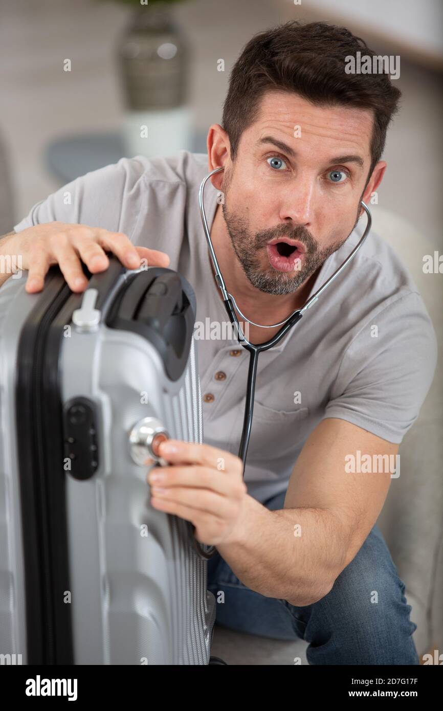 thoughtful man traveler standing behind his luggage Stock Photo - Alamy