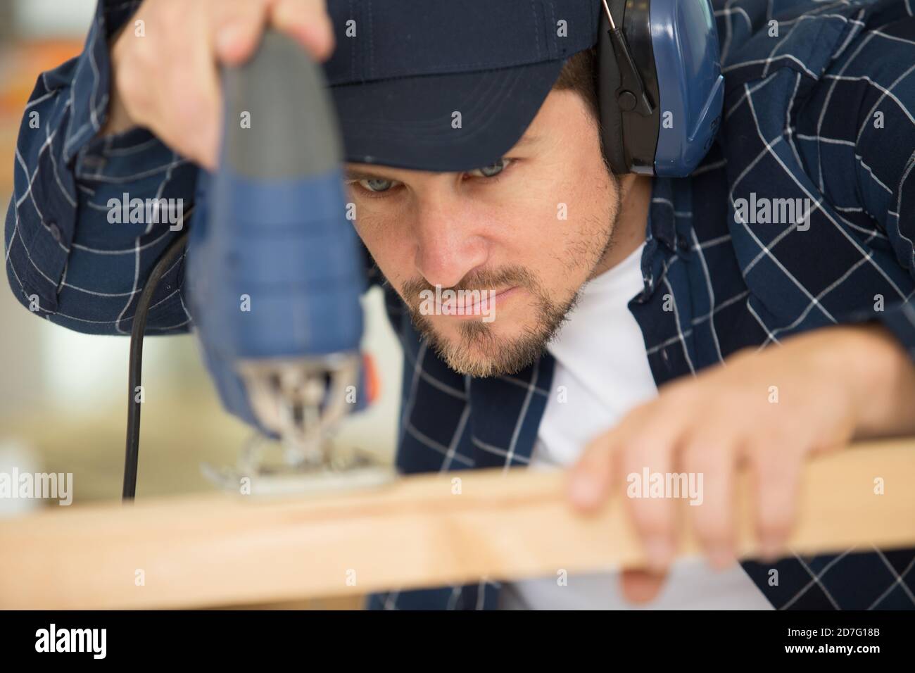 a man is using an electrical saw Stock Photo - Alamy