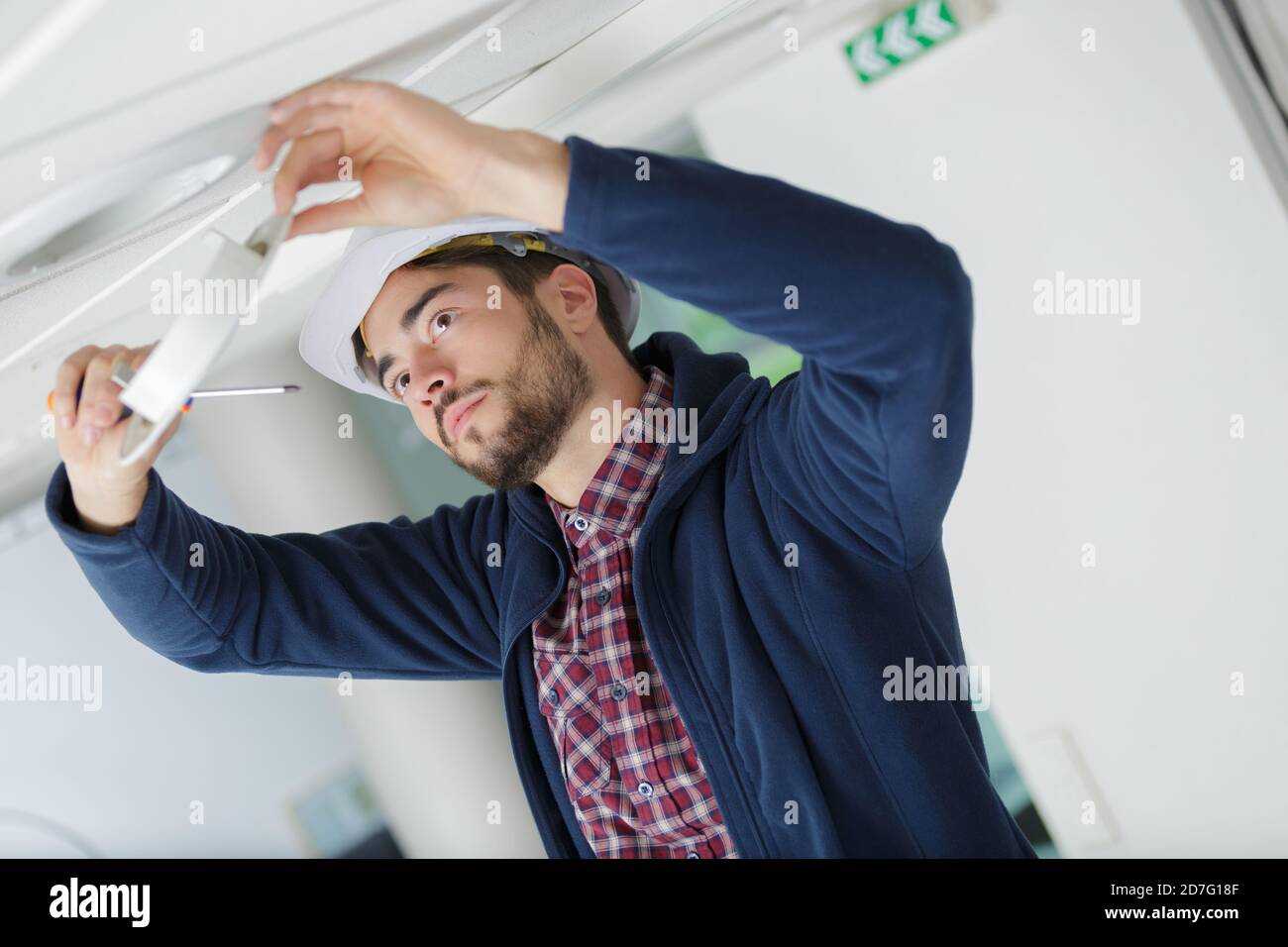 a construction worker fixing ceiling Stock Photo - Alamy