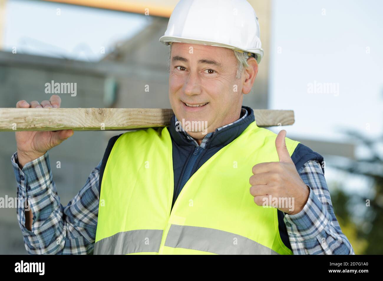 rear view portrait of mature workman carrying long wooden board Stock ...