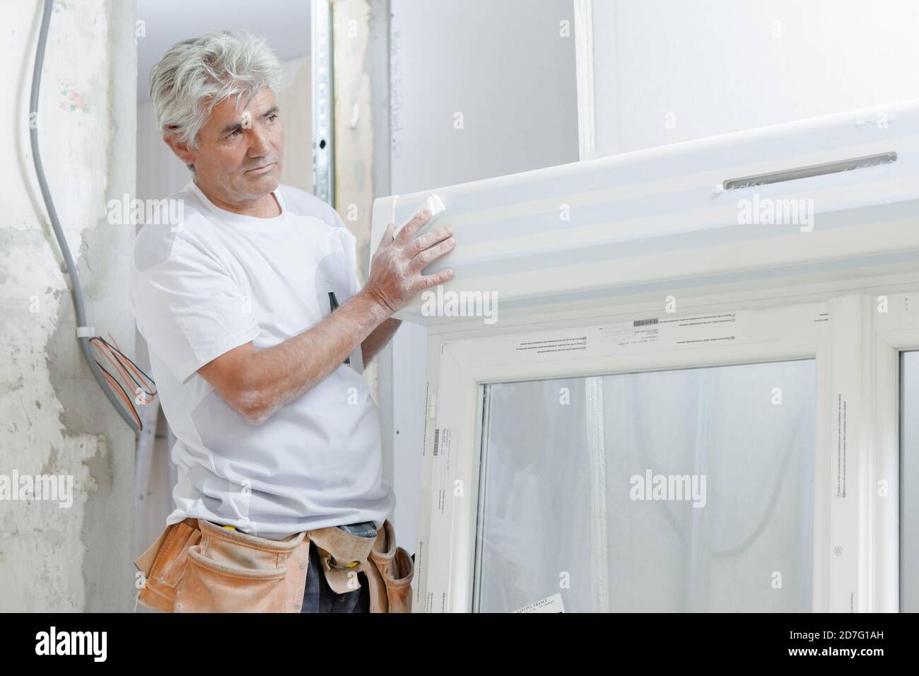 man is carrying a new window Stock Photo - Alamy
