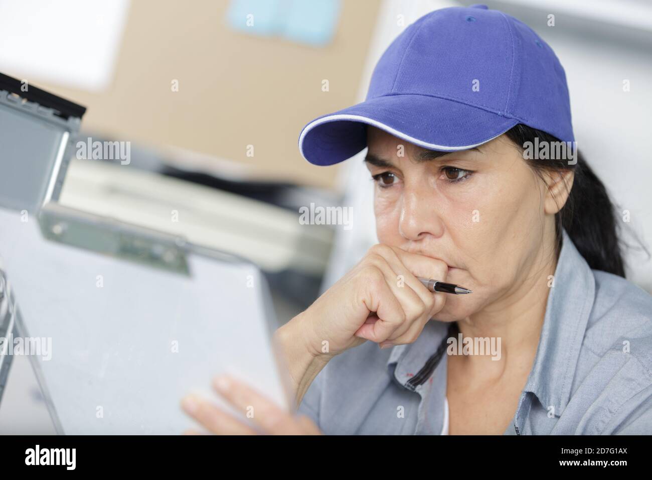 female engineer reading project plan Stock Photo - Alamy