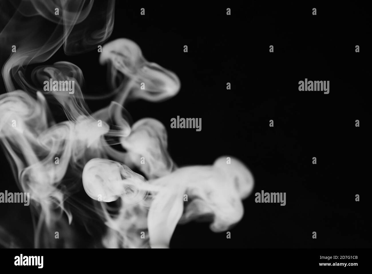 White smoke on a black background. Texture of smoke. Clubs of white ...