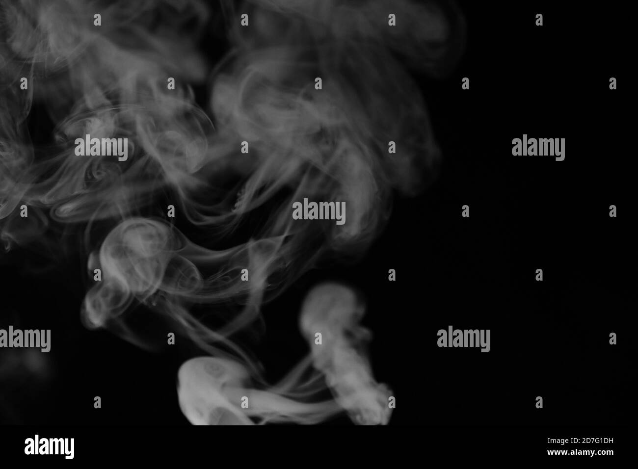 White smoke on a black background. Texture of smoke. Clubs of white ...