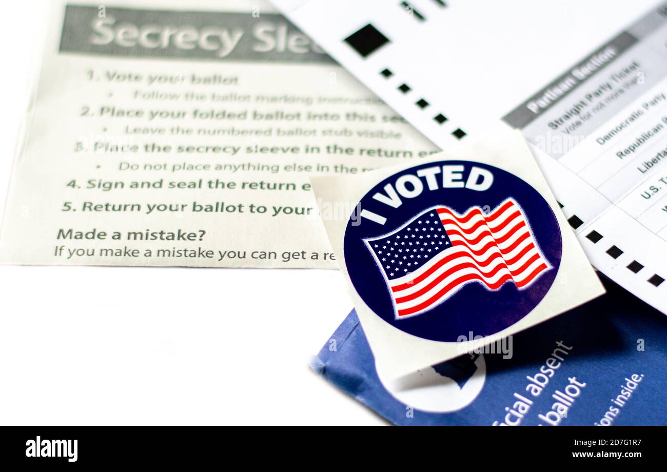 Absent voter forms and a vivid I voted sticker are displayed, with room ...