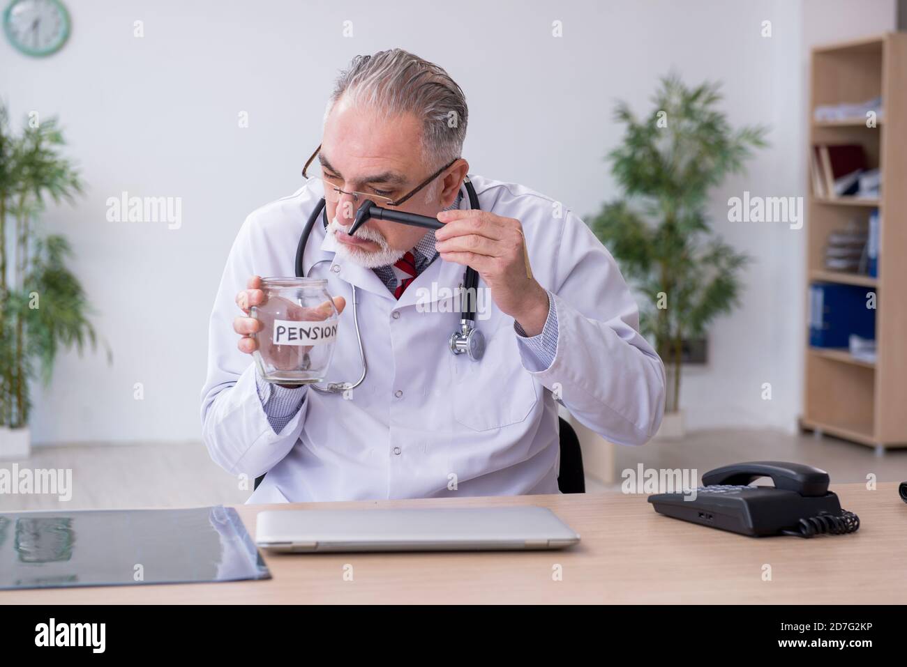 Old doctor in retirement concept Stock Photo - Alamy