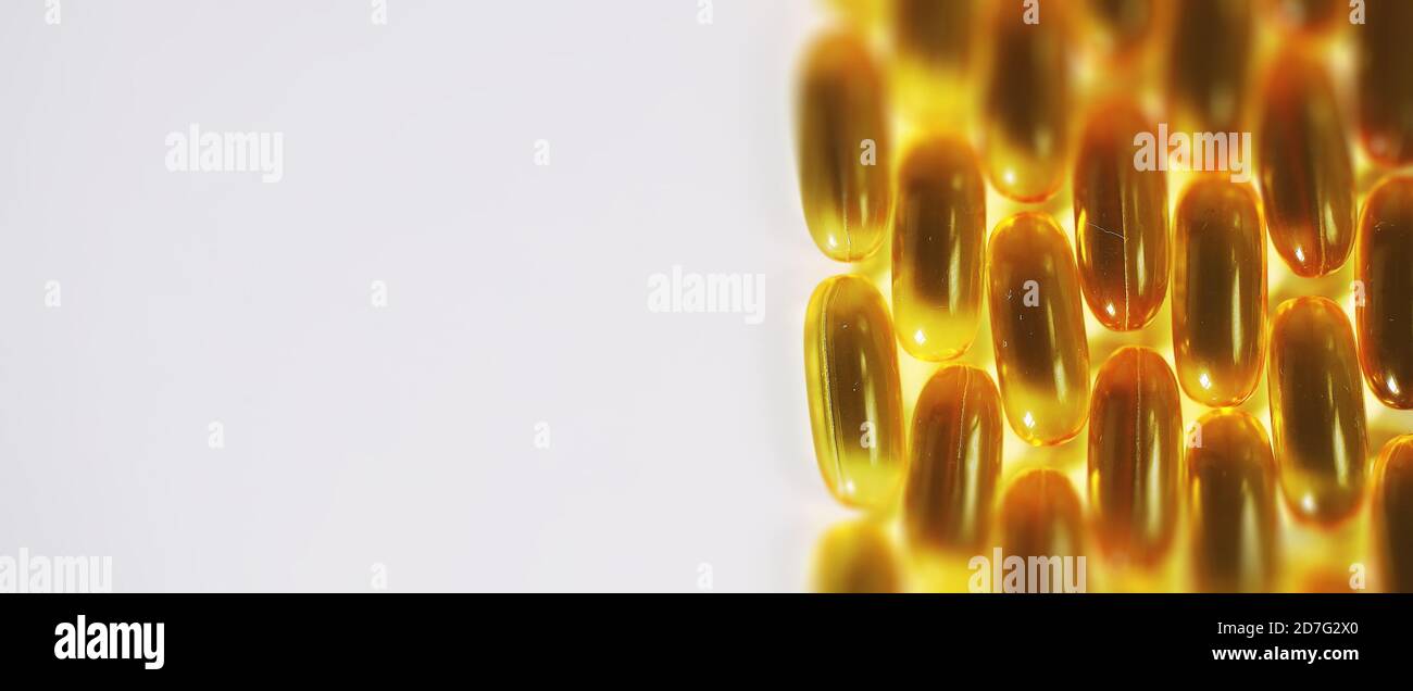 Medical medicines and supplements transparent capsules of yellow color ...