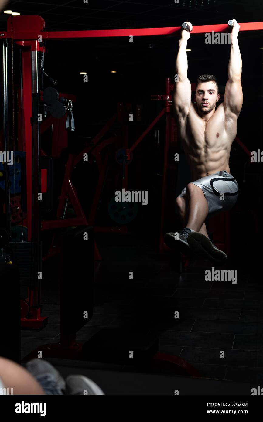 Athlete Performing Hanging Leg Raises Exercise - One Of The Most ...