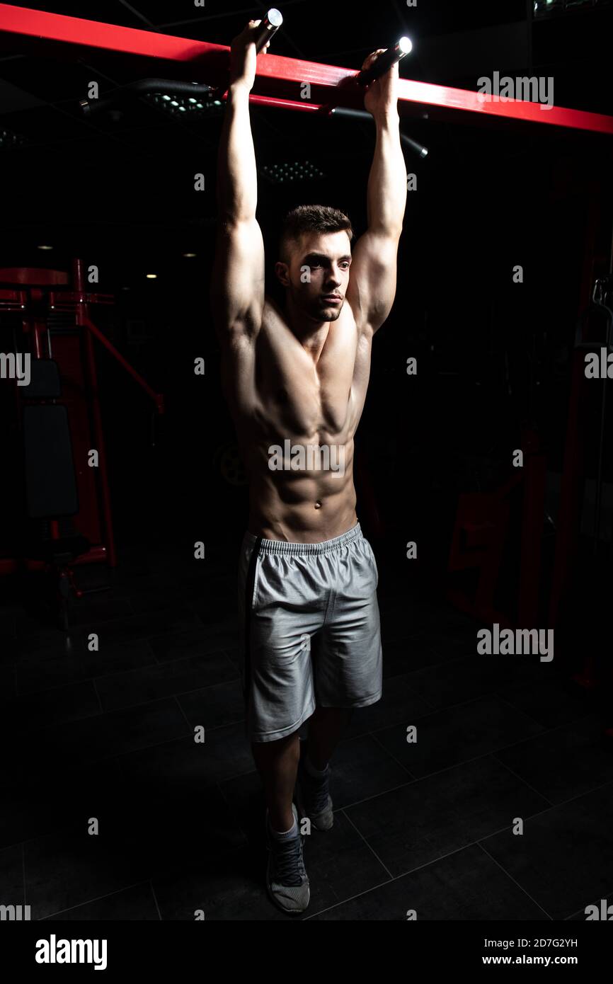 Athlete Performing Hanging Leg Raises Exercise - One Of The Most ...