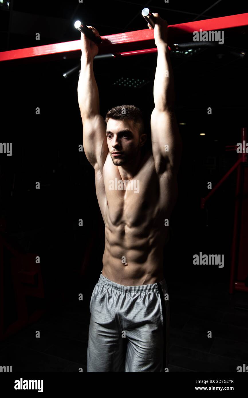 Athlete Performing Hanging Leg Raises Exercise - One Of The Most ...