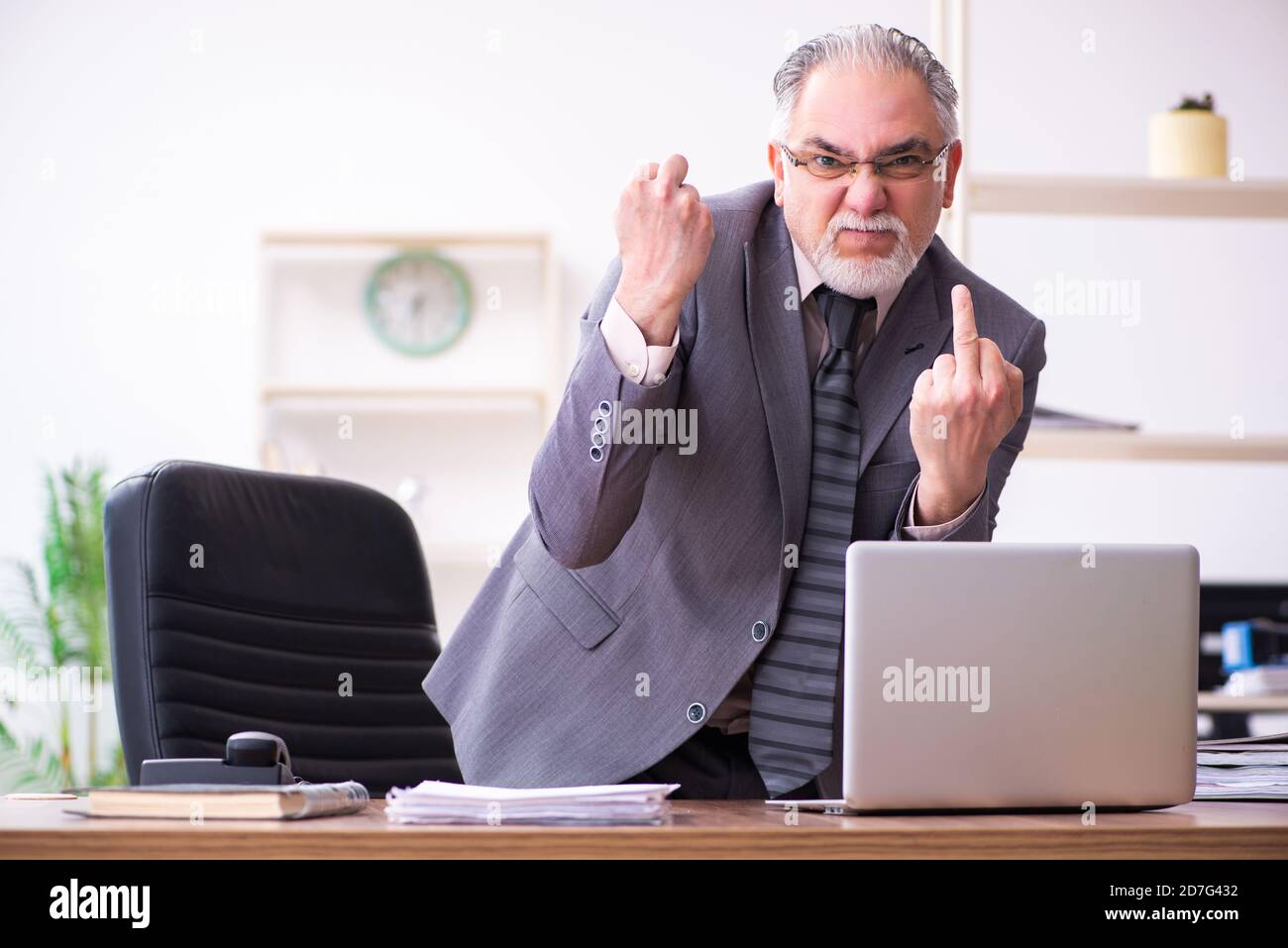 Businessman angry and furious at his workplace Stock Photo - Alamy