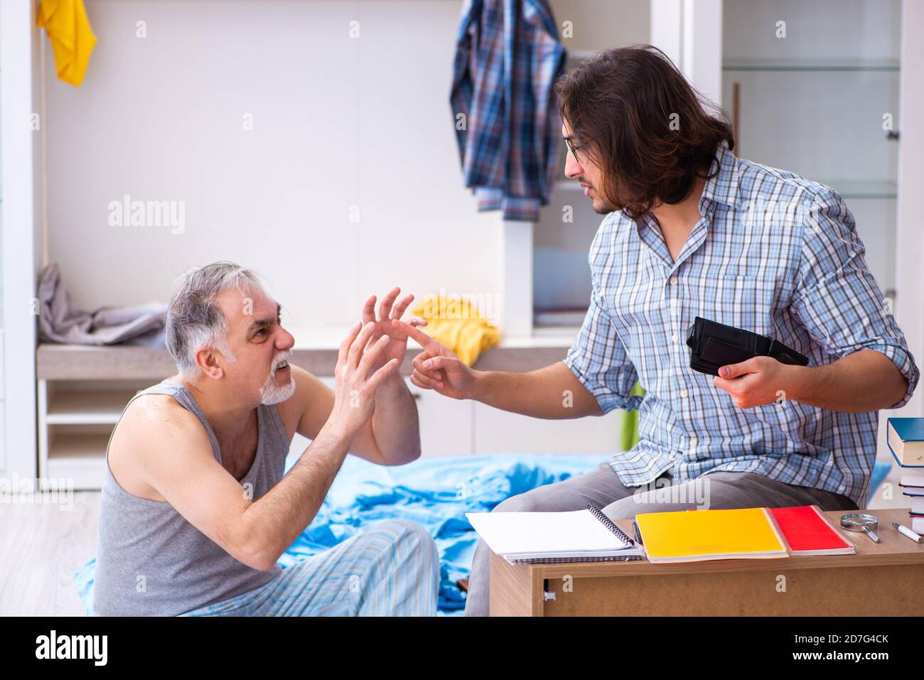 Young son student and dad alcoholic at home Stock Photo - Alamy