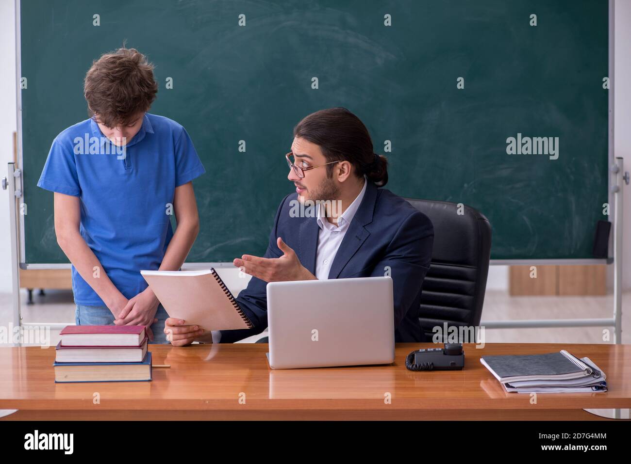 Male teacher and schoolboy in the classroom Stock Photo - Alamy
