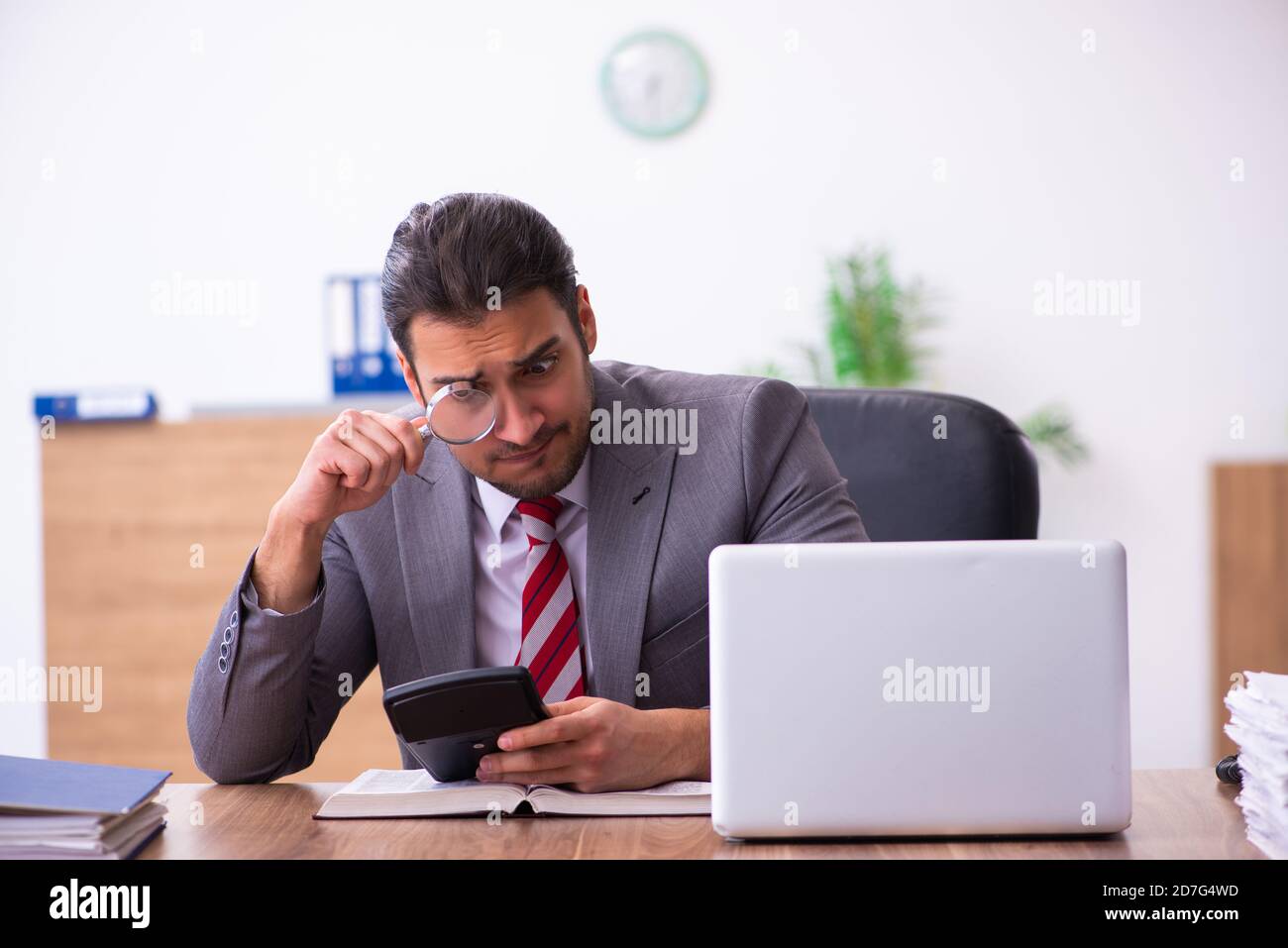 Male bookkeeper working in the office Stock Photo - Alamy