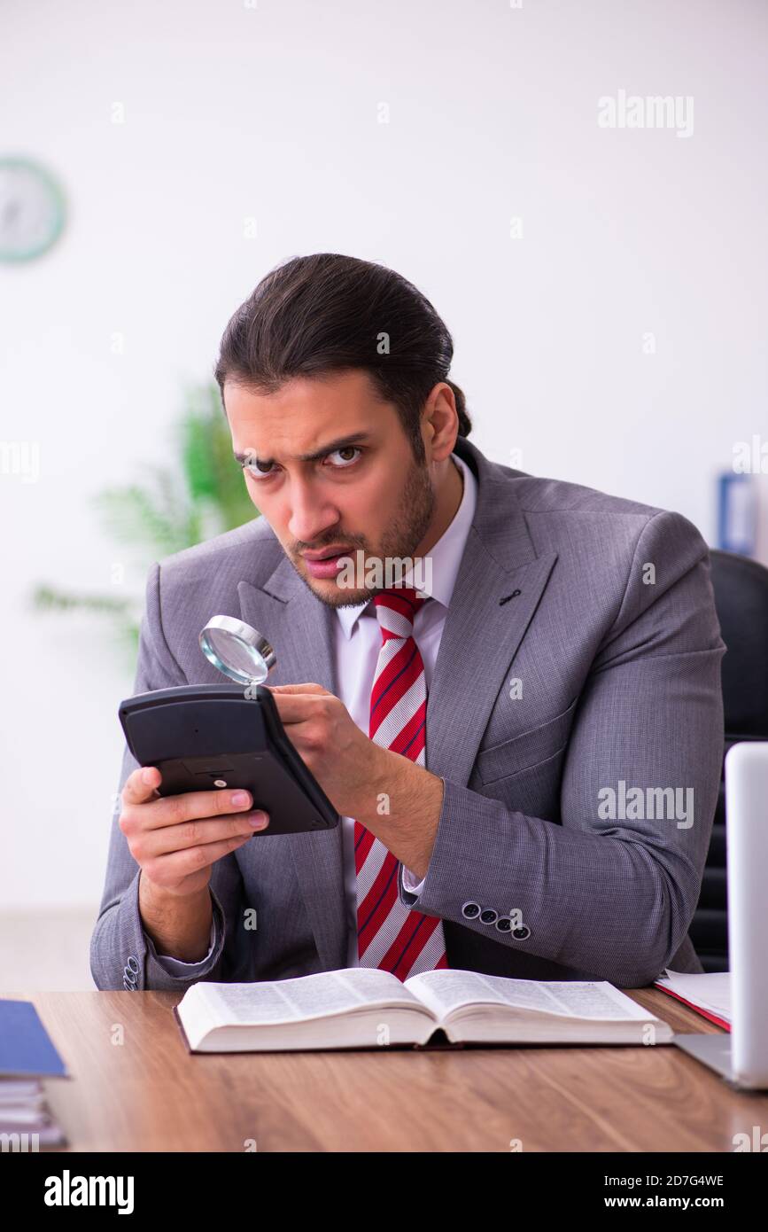 Male bookkeeper working in the office Stock Photo - Alamy