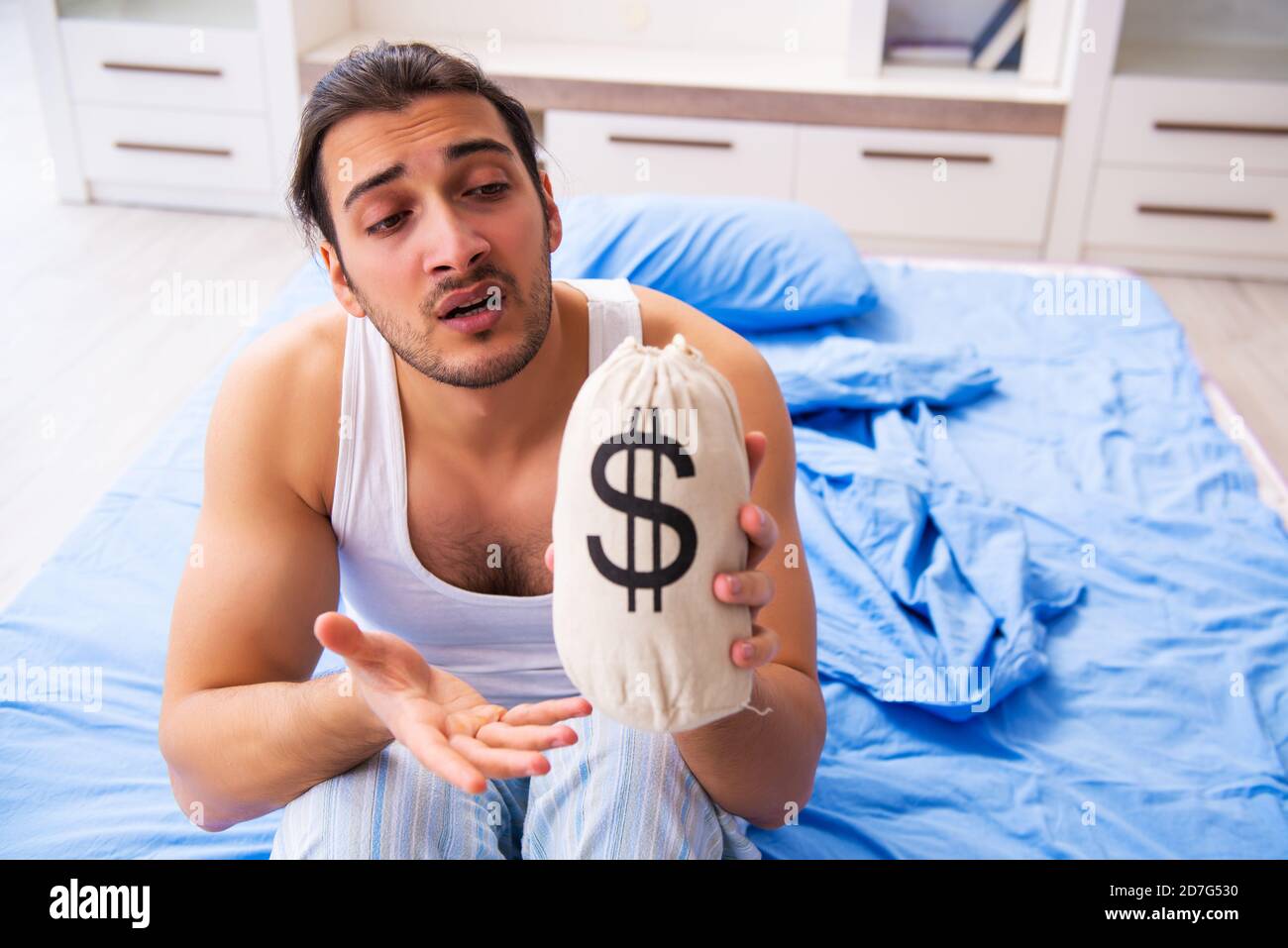 Young man in insolvency concept Stock Photo - Alamy