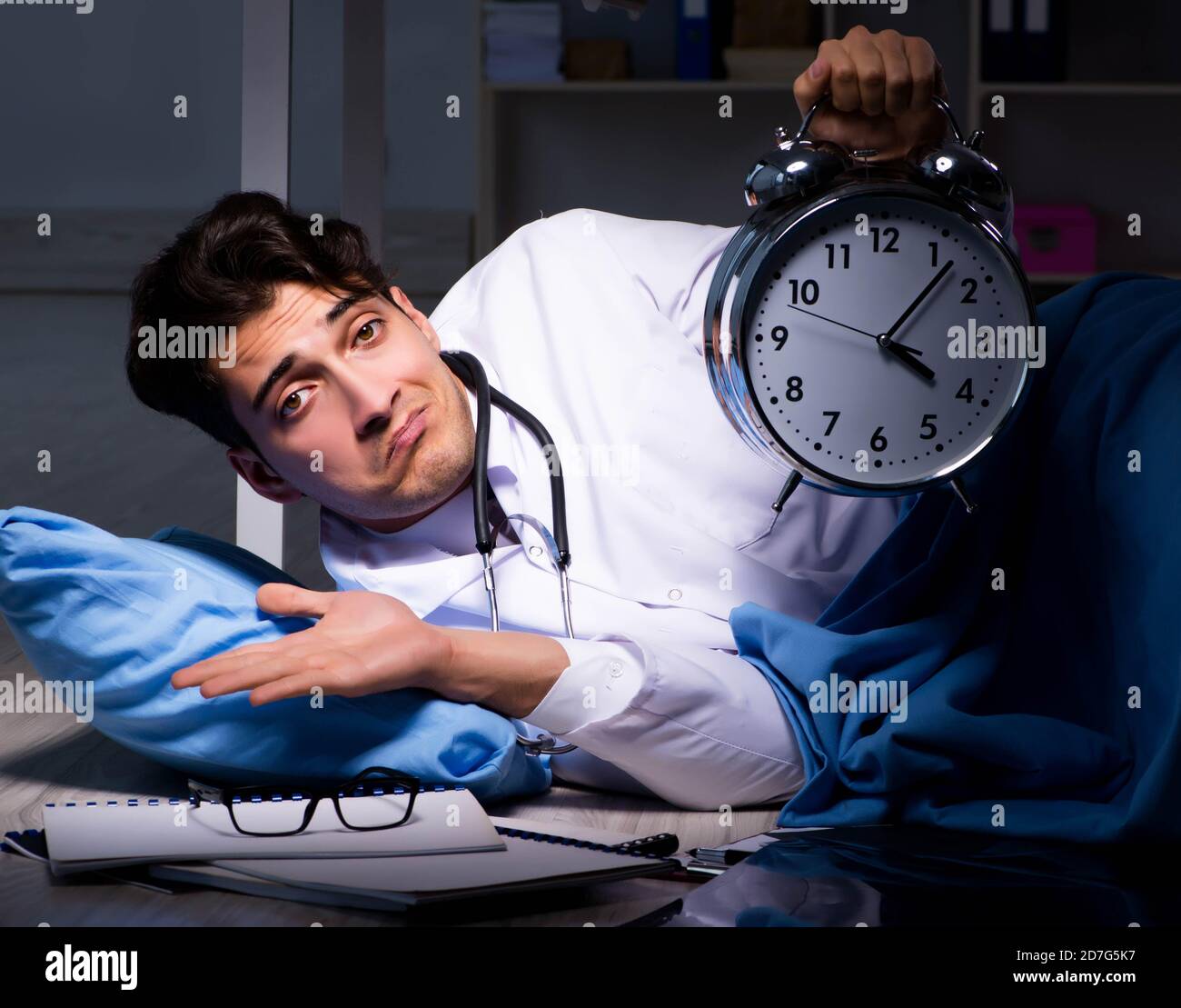 Doctor working long hours hi-res stock photography and images - Alamy
