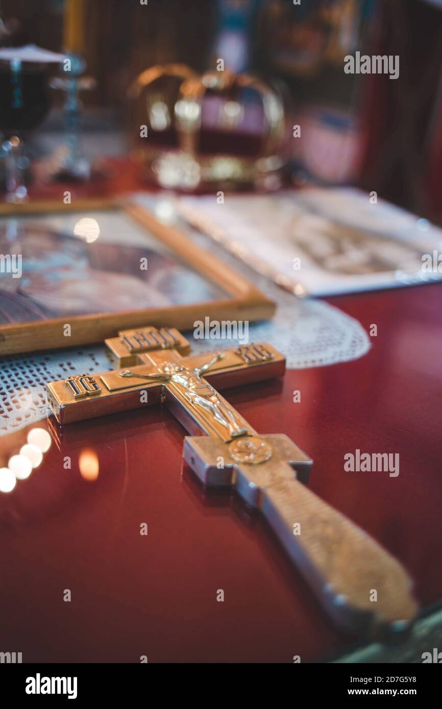 Vertical shot of a golden cross on an antique table Stock Photo - Alamy