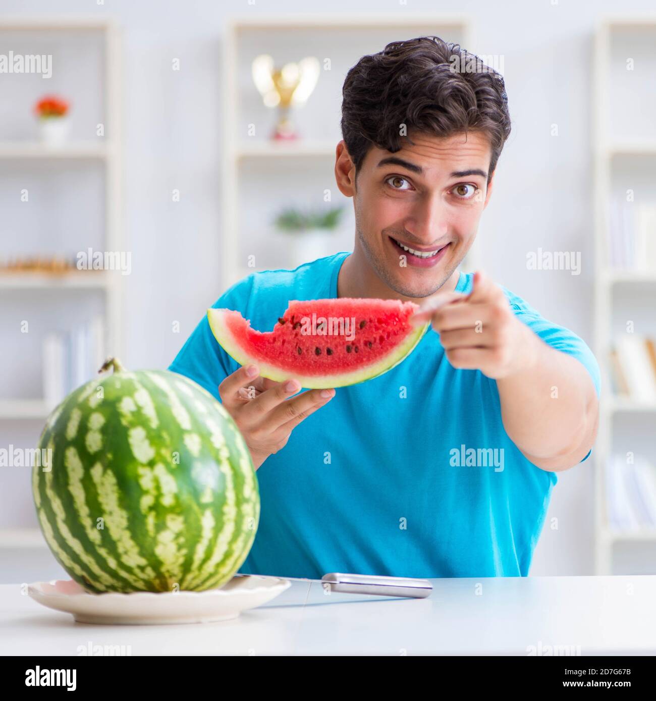 The man eating watermelon at home Stock Photo - Alamy