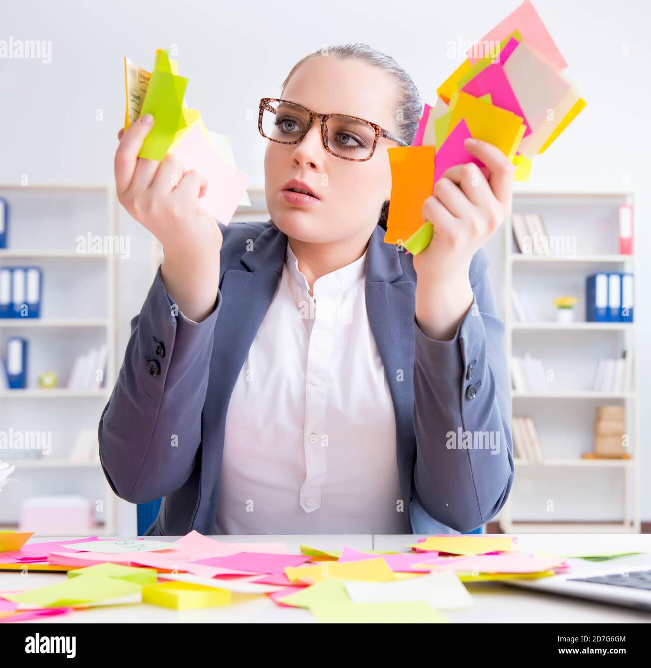 Businesswoman with conflicting priorities in office Stock Photo - Alamy