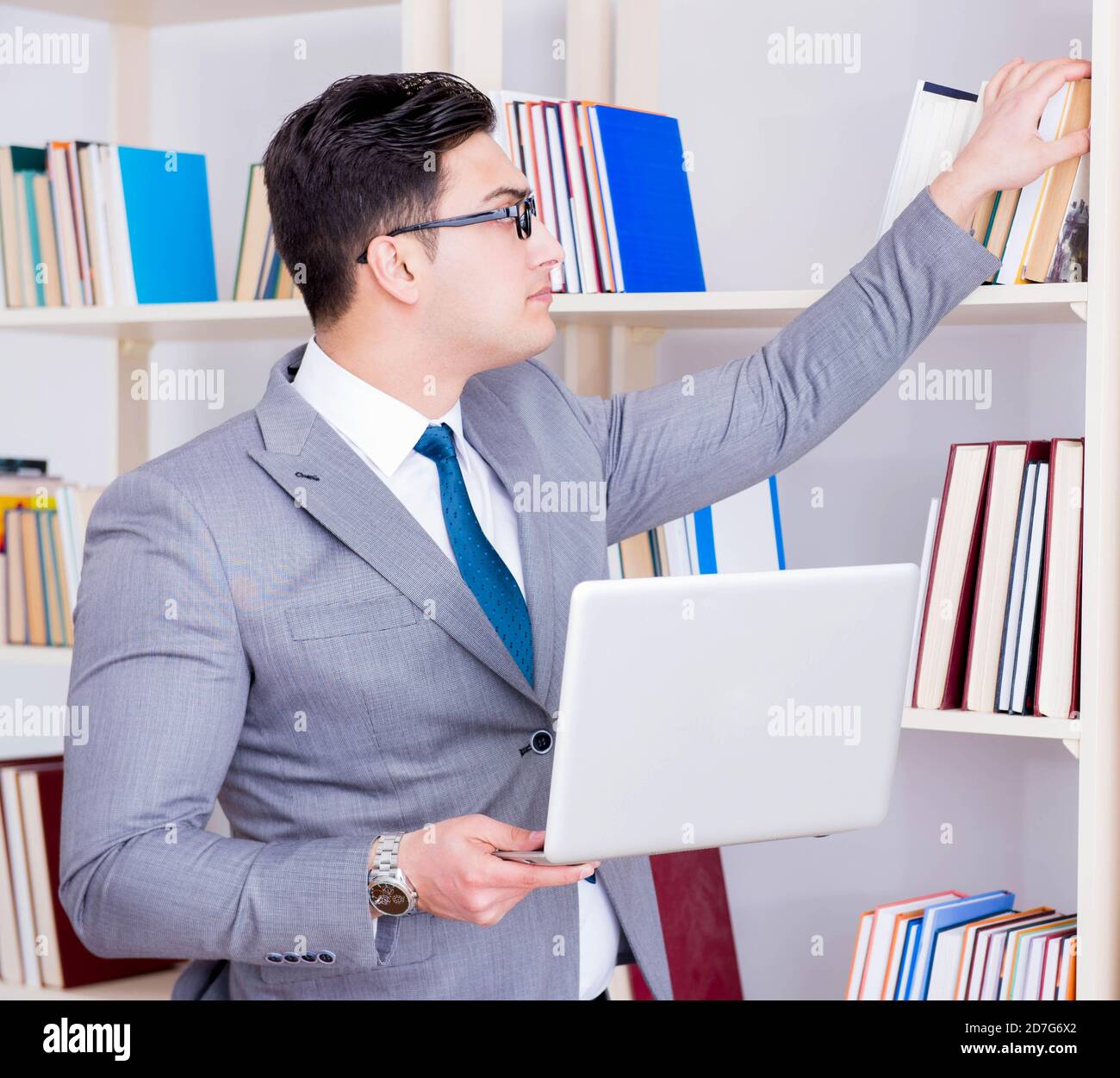 The businessman with a laptop working in the library Stock Photo - Alamy