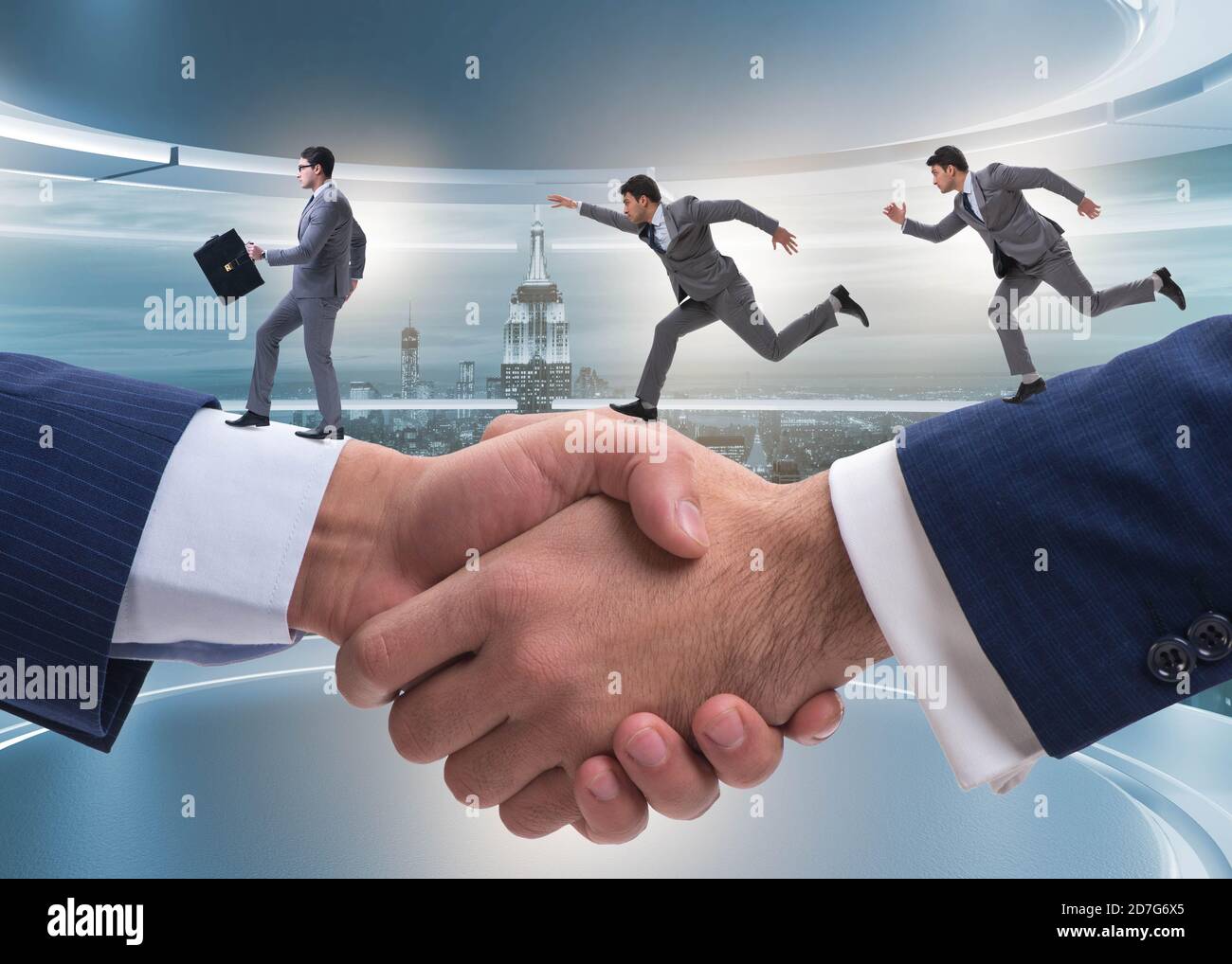 Cooperation concept with people running on handshake Stock Photo - Alamy