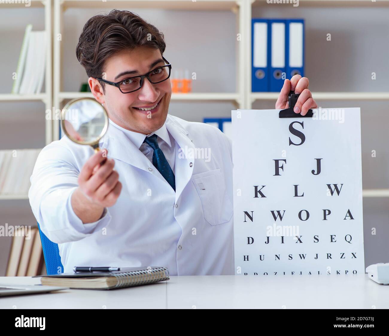 The doctor optician with letter chart conducting an eye test check ...