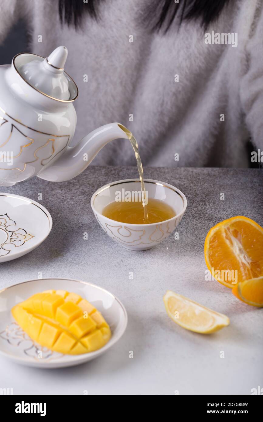 Morning breakfast. Freshly brewed tea is poured into a bowl. Concept ...
