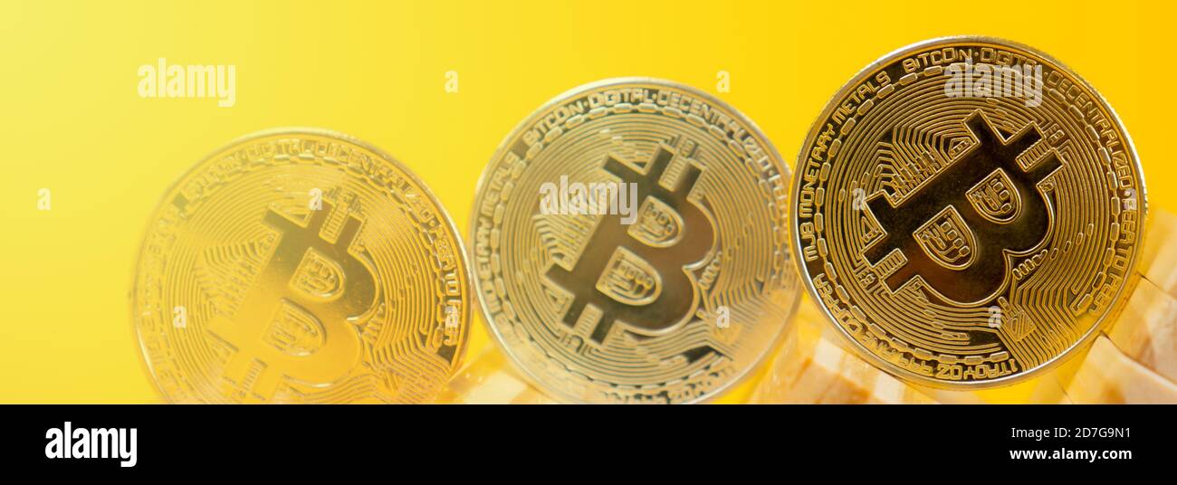 Bitcoin on the yellow background Stock Photo - Alamy