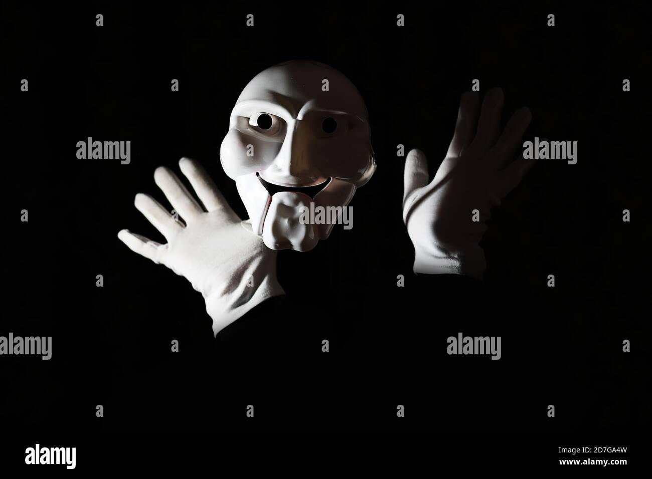 White scary mask on a black background with whites hands Stock Photo ...
