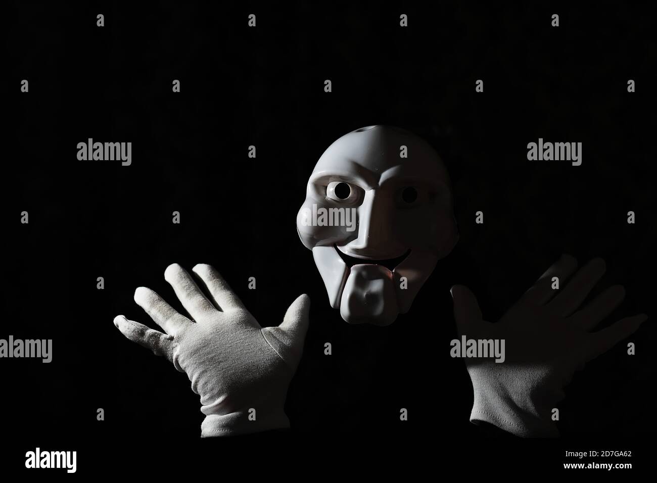 White scary mask on a black background with whites hands Stock Photo ...