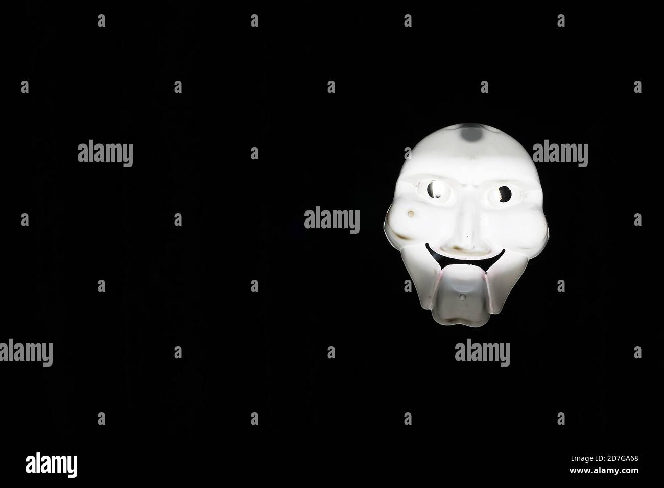 White scary mask on a black background with whites hands Stock Photo ...