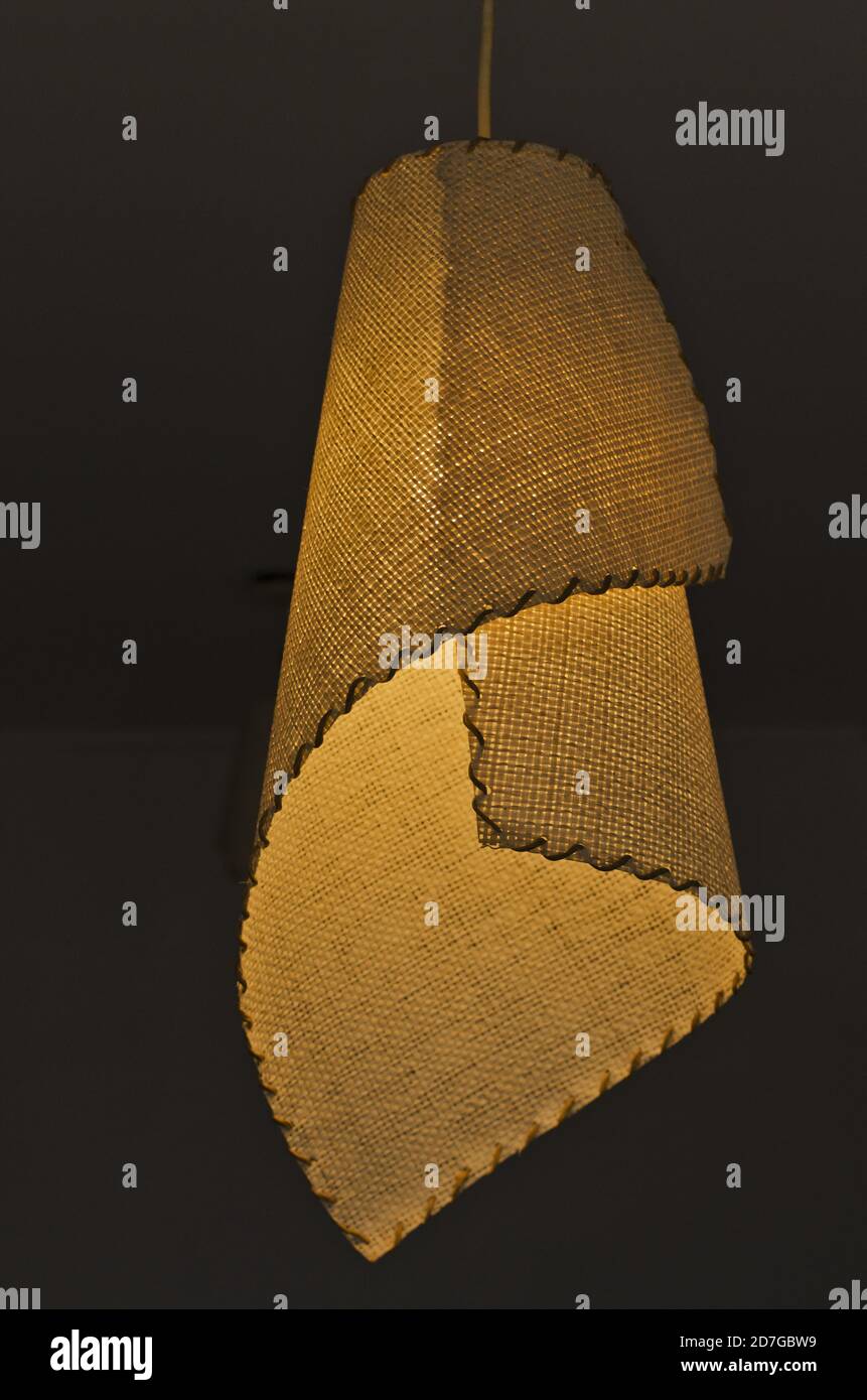 Low angle shot of hanging hand-made pendant lamp in an envelope shape ...