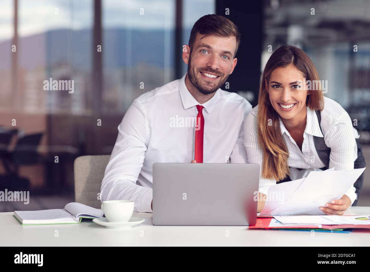 Couple of busy colleagues working together in modern office Stock Photo ...