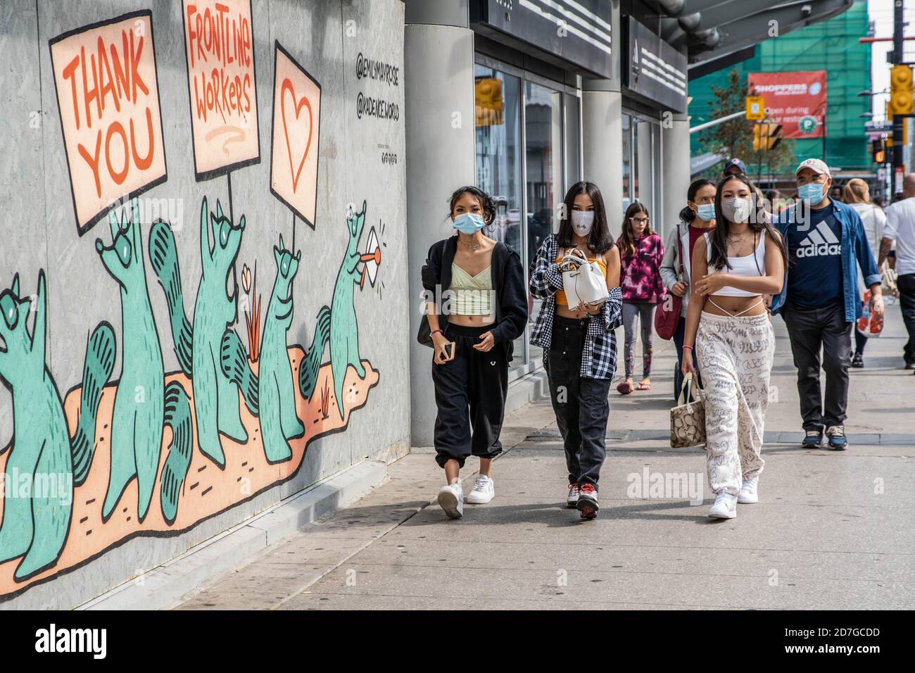 Women wearing face masks as a precaution walking in downtown Toronto ...
